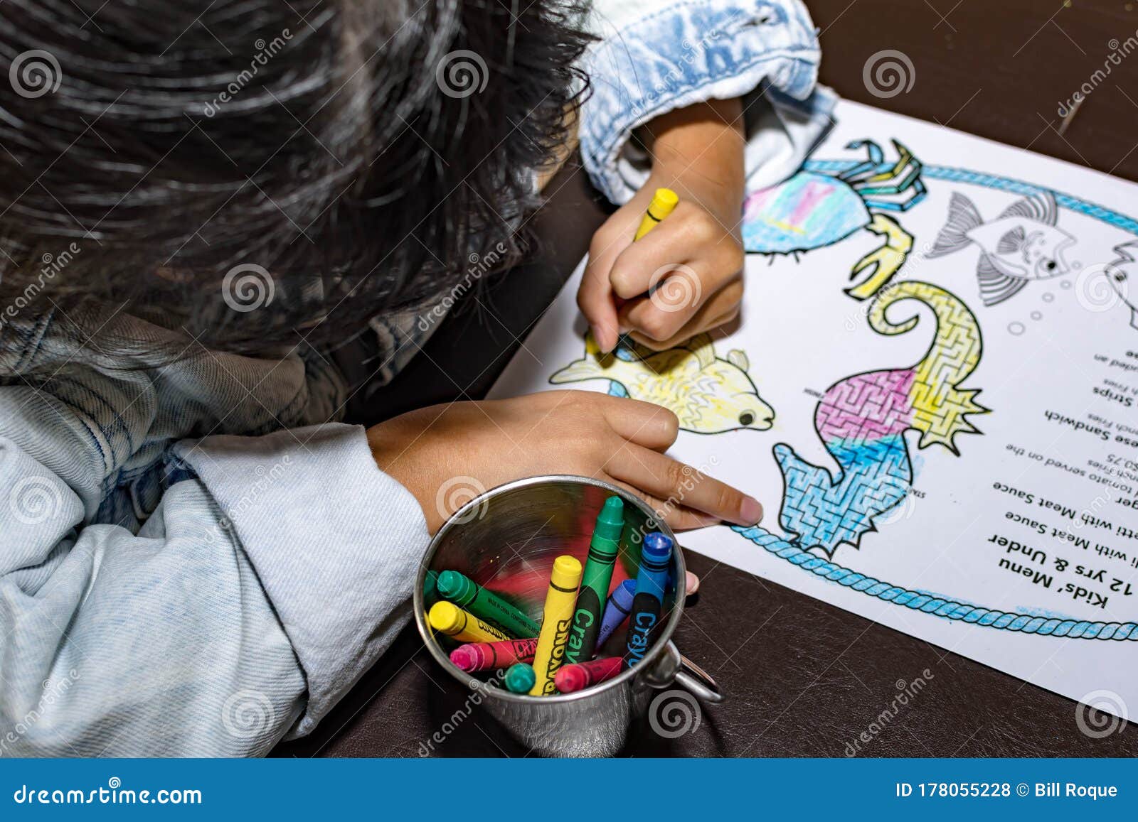 Pretty Asian Child Left Handed while Doing a Coloring Activity with ...