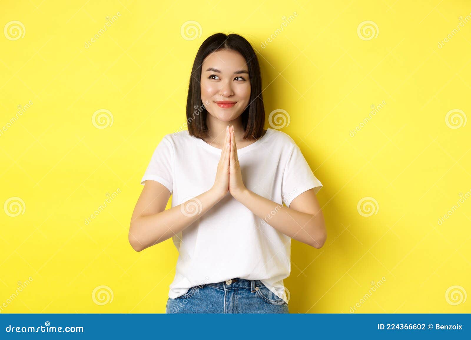 Pretty Asian Woman Holding Hands In Namaste Pray Gesture Looking Left
