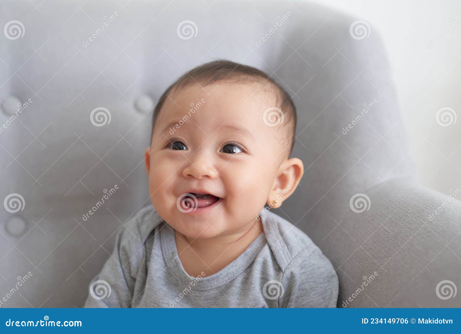 Pretty Baby Sitting and Smiling on the Sofa Stock Photo - Image of love ...