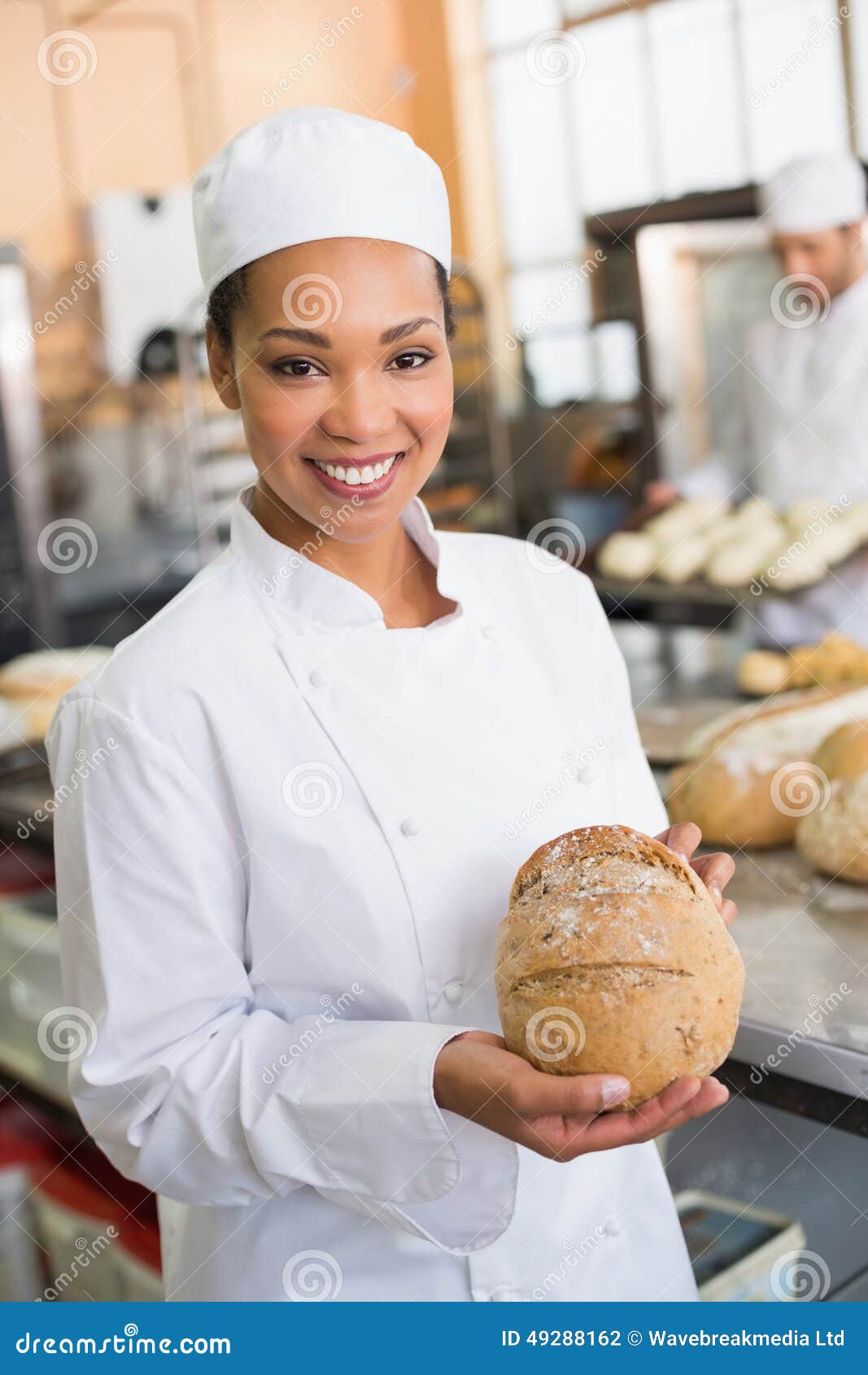 Pretty Baker Smiling at Camera with Loaf Stock Photo - Image of bread ...