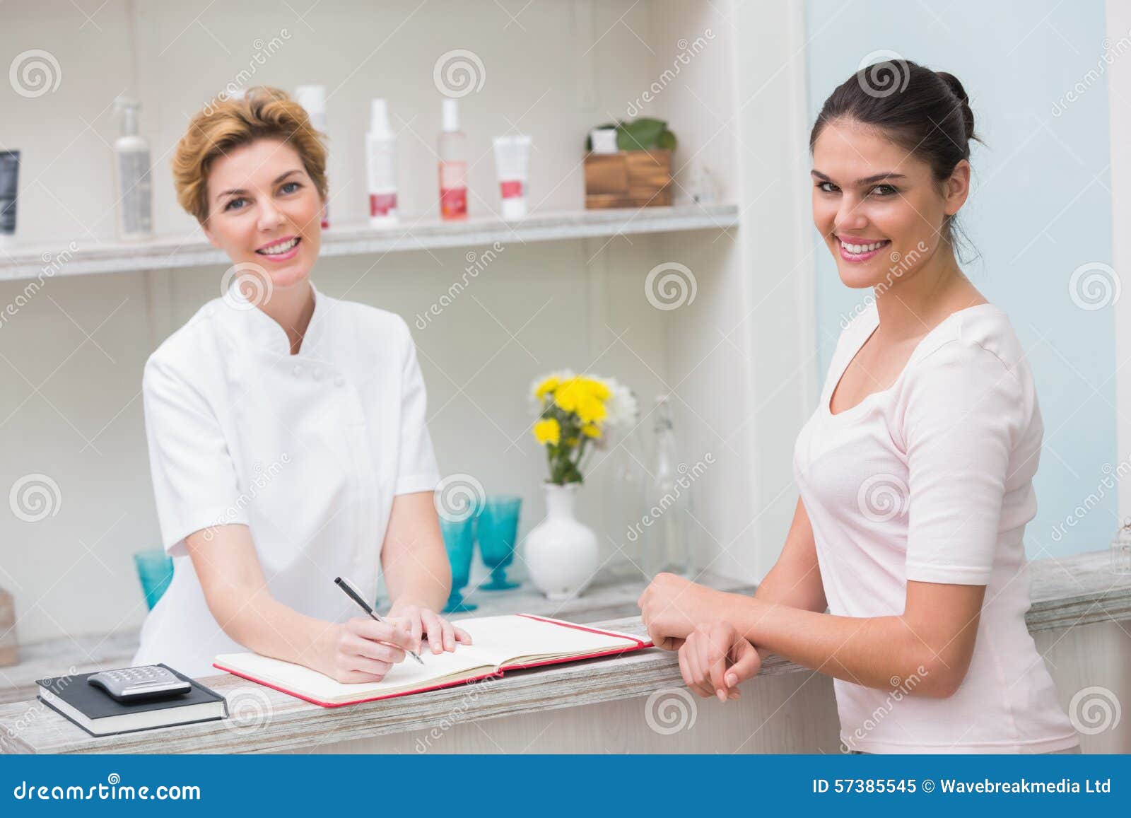 Pretty Beautician Smiling with Client Stock Image - Image of foreground ...