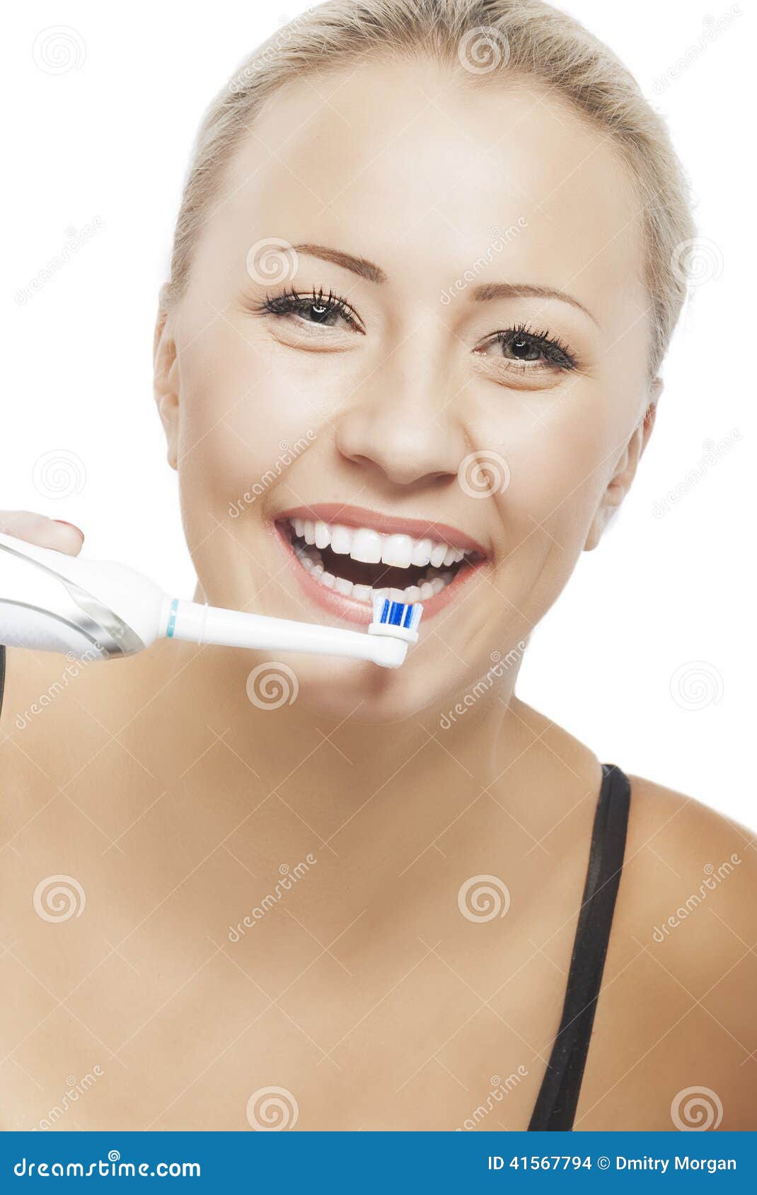 Pretty Blond Smiling Woman Cleaning Her Teeth With Modern Electric