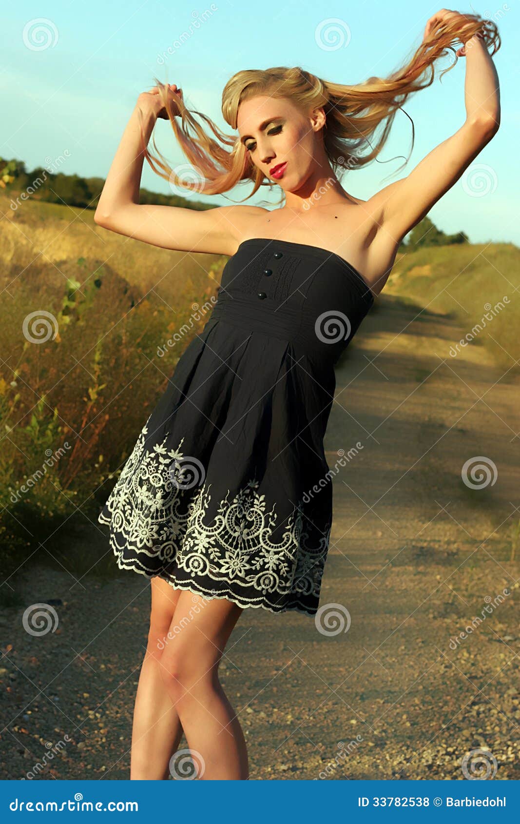 Pretty Blond Walks Down Path Stock Photo - Image of glamour, glamor ...