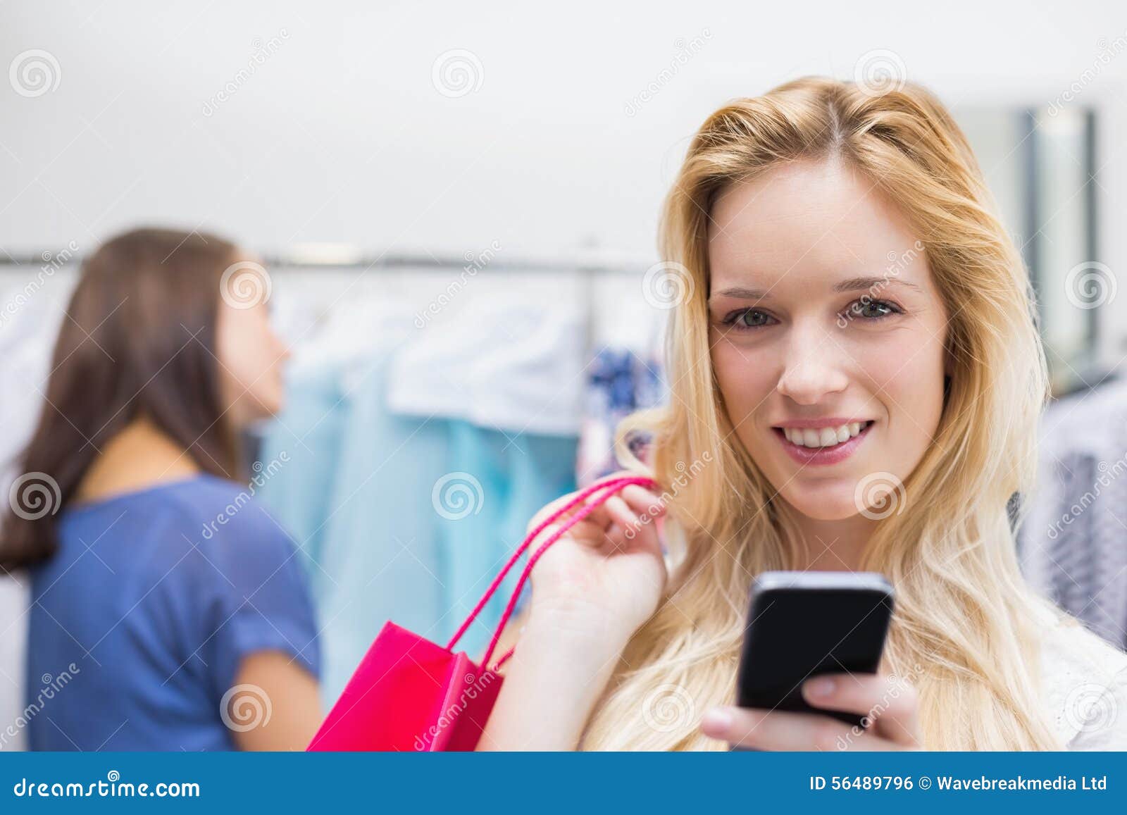 Pretty Blonde Sending a Text Message Stock Photo - Image of rack ...