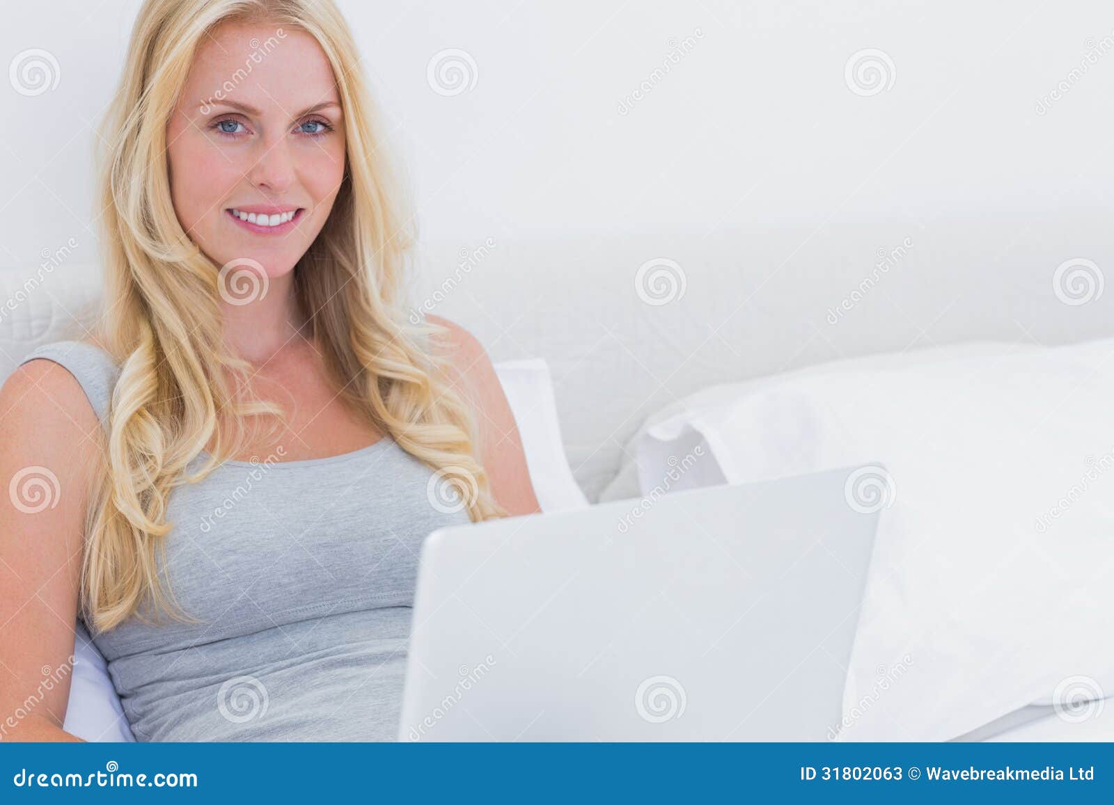 Pretty Blonde Woman Using Her Laptop Stock Image - Image of comforter ...