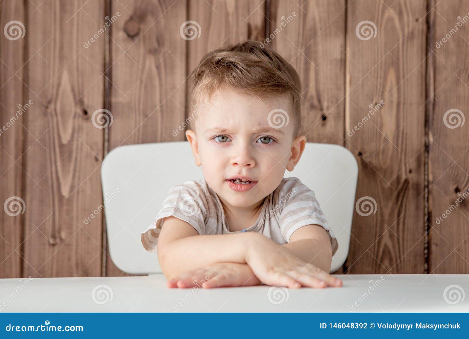 A Pretty Boy is Sitting at the Table. Close-up Stock Photo - Image of ...