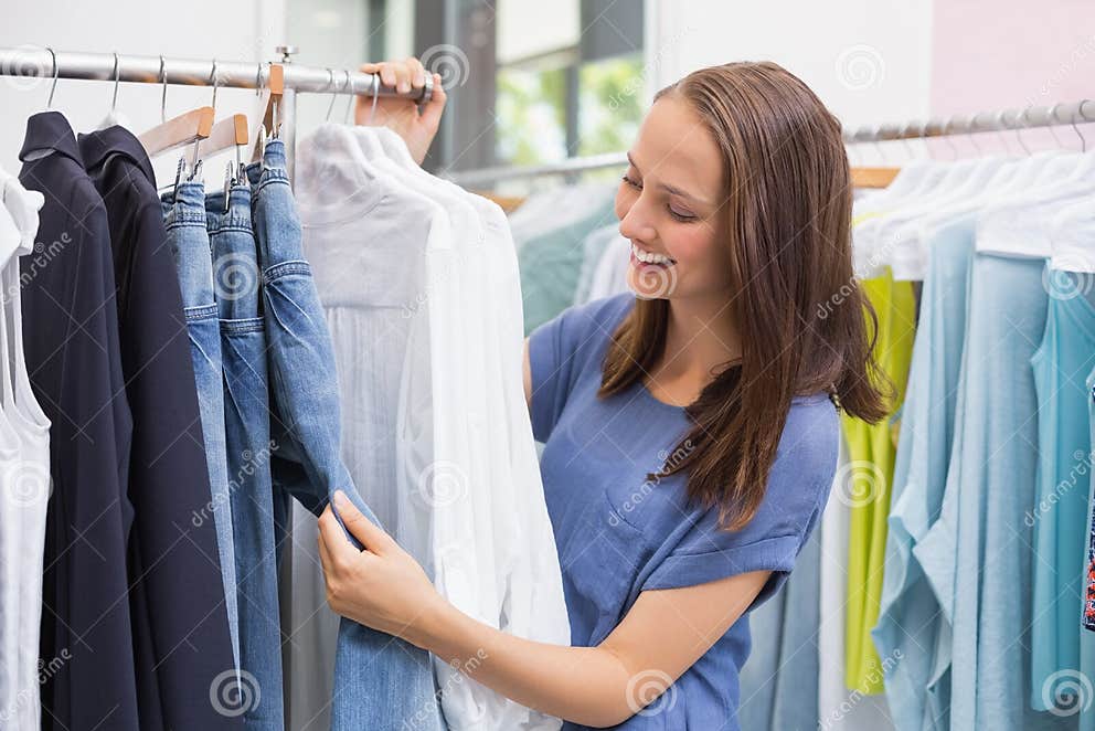 Pretty Brunette Browsing in the Clothes Rack Stock Photo - Image of ...