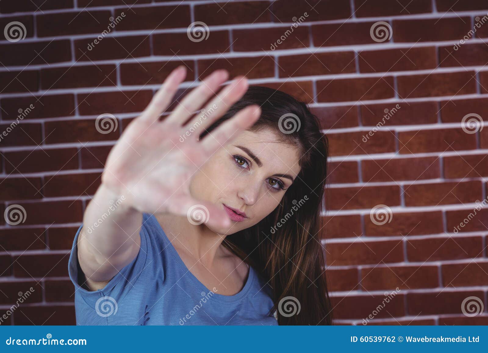Pretty Brunette with Hand Up Stock Photo - Image of caucasian, stern ...
