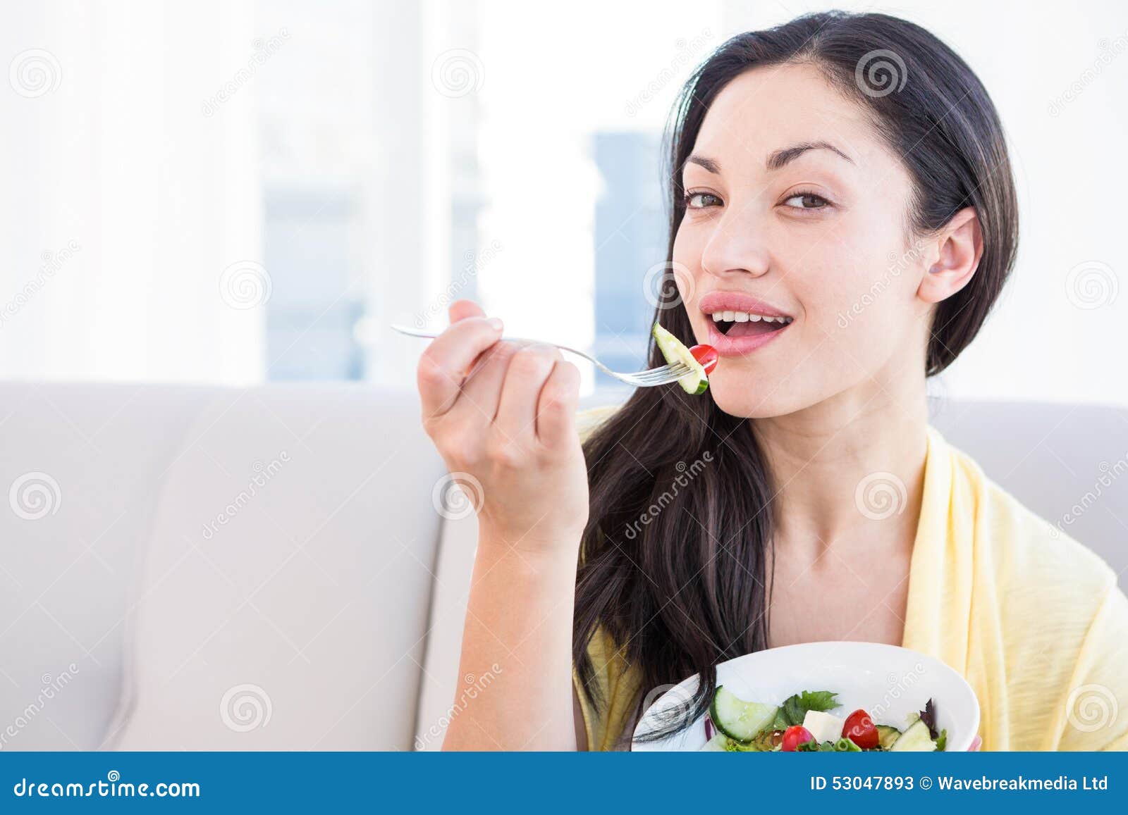Pretty Brunette Looking at Camera and Eating Vegetables Stock Image ...