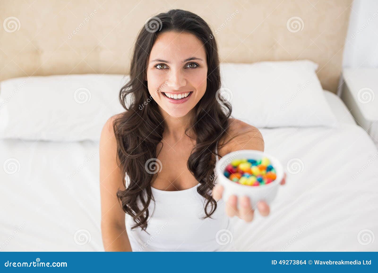 Pretty Brunette Offering Candy in Bed Stock Photo - Image of female ...