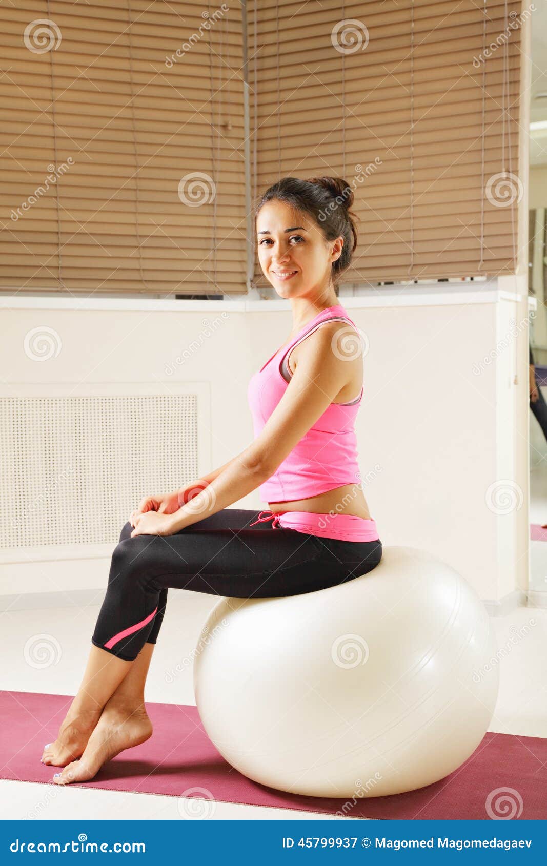 Pretty Brunette Sitting on a Ball Stock Image - Image of caucasian ...