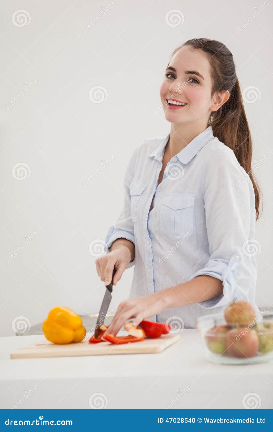 Pretty Brunette Slicing Up Peppers Stock Photo - Image of smiling ...