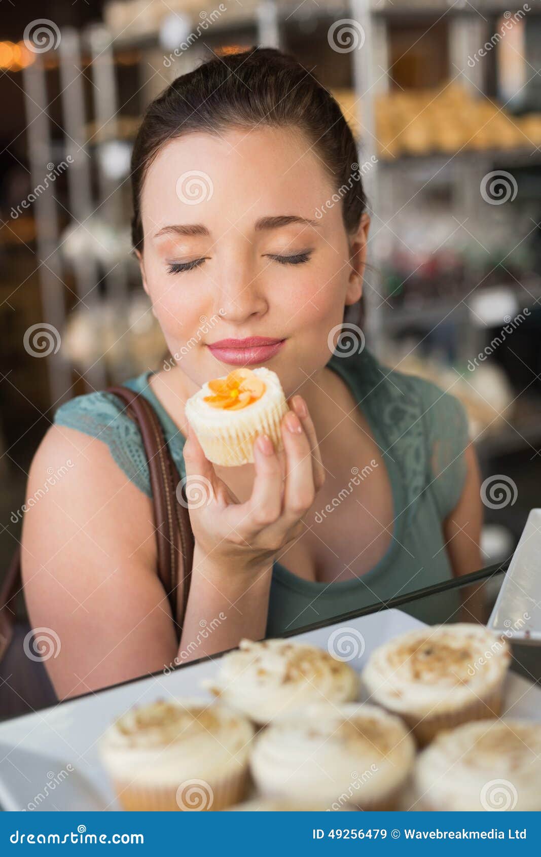 Pretty Brunette Smelling a Cupcake Stock Image - Image of holding ...