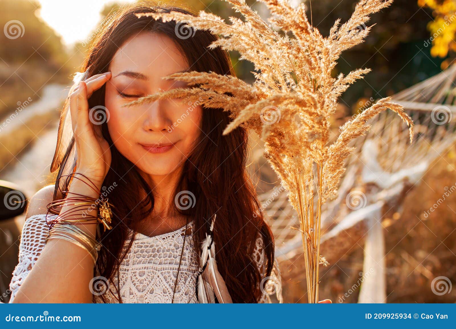 Carefree Boho Girl In White Summer Dress Walking In Sunny Rural Field