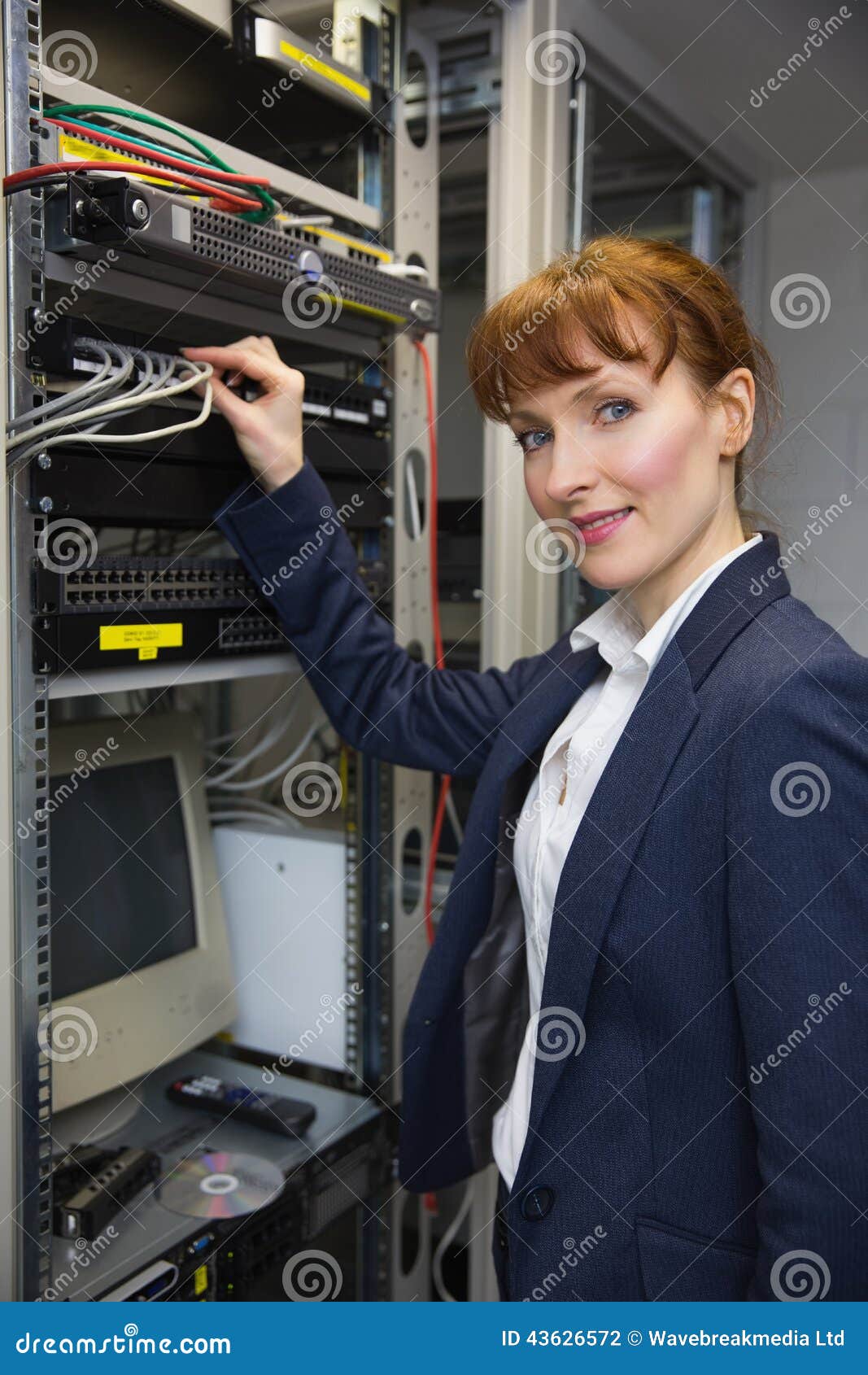 Pretty Computer Technician Smiling at Camera while Fixing Server Stock ...