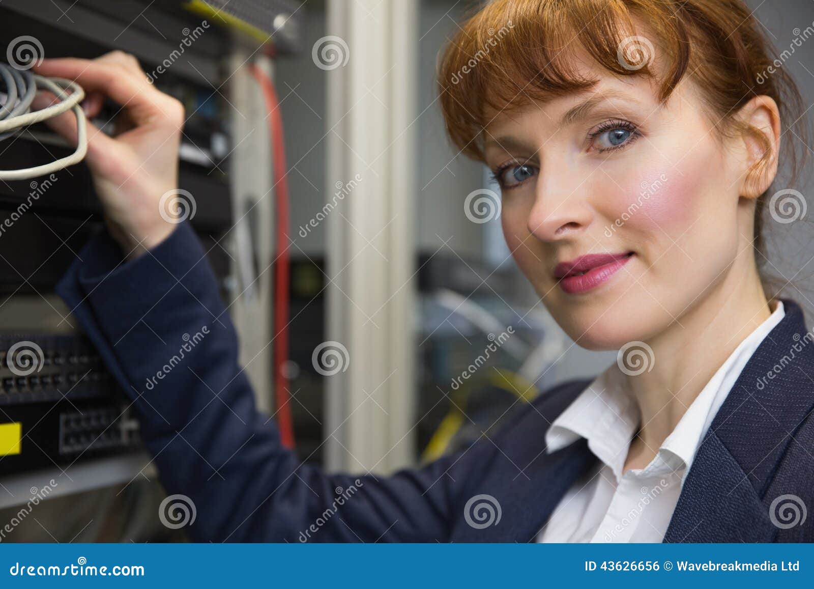 Pretty Computer Technician Smiling at Camera while Fixing Server Stock ...
