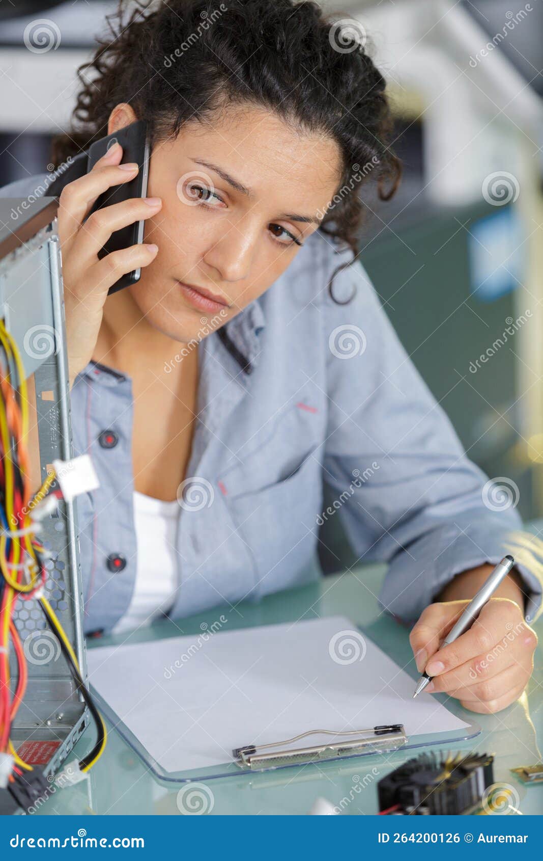 Pretty Computer Technician Talking on Phone while Fixing Server Stock ...