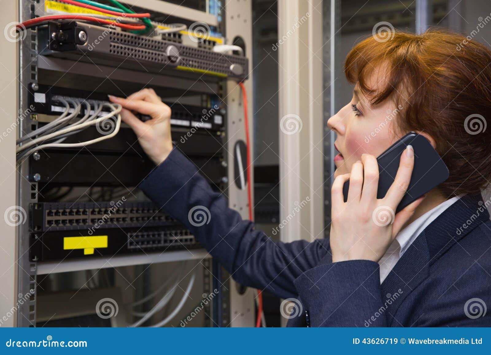 Pretty Computer Technician Talking on Phone while Fixing Server Stock ...