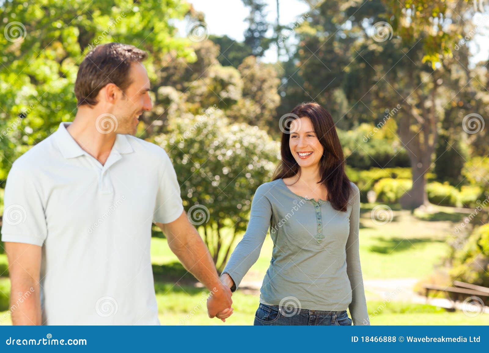 Pretty couple in the park stock photo. Image of green - 18466888