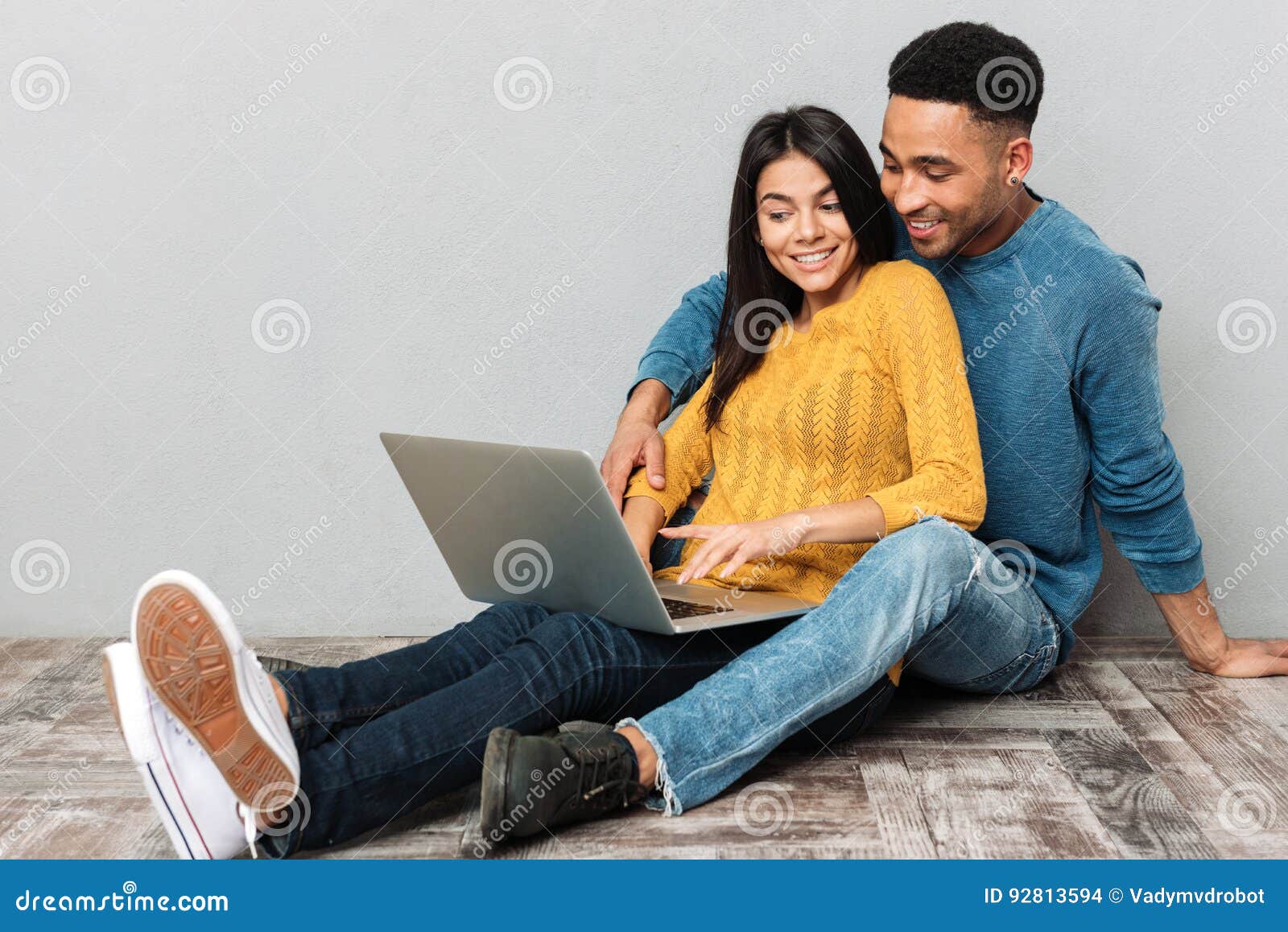 Pretty couple using laptop stock photo. Image of technology - 92813594