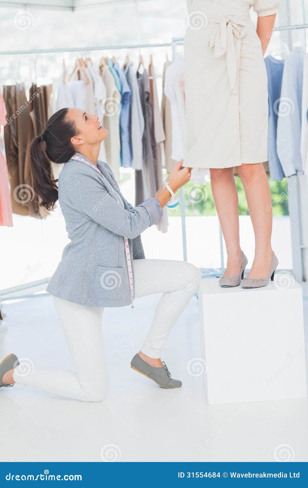 Pretty Designer Adjusting Dress Stock Photo - Image of cool, kneeling ...