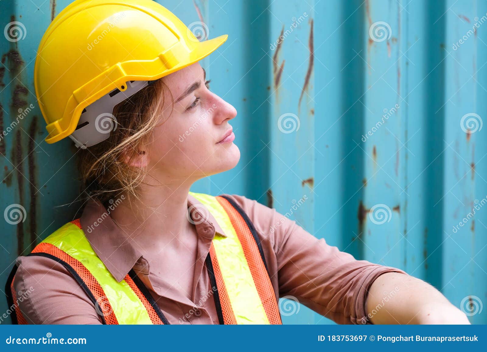 Pretty Engineer Worker Sitting on the Floor in Front of the Container ...