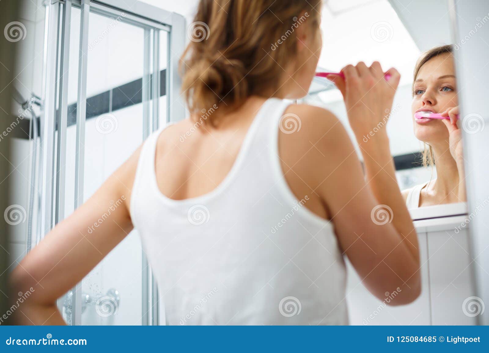 Pretty Female Brushing Her Teeth In Front Of Mirror Stock Image Image