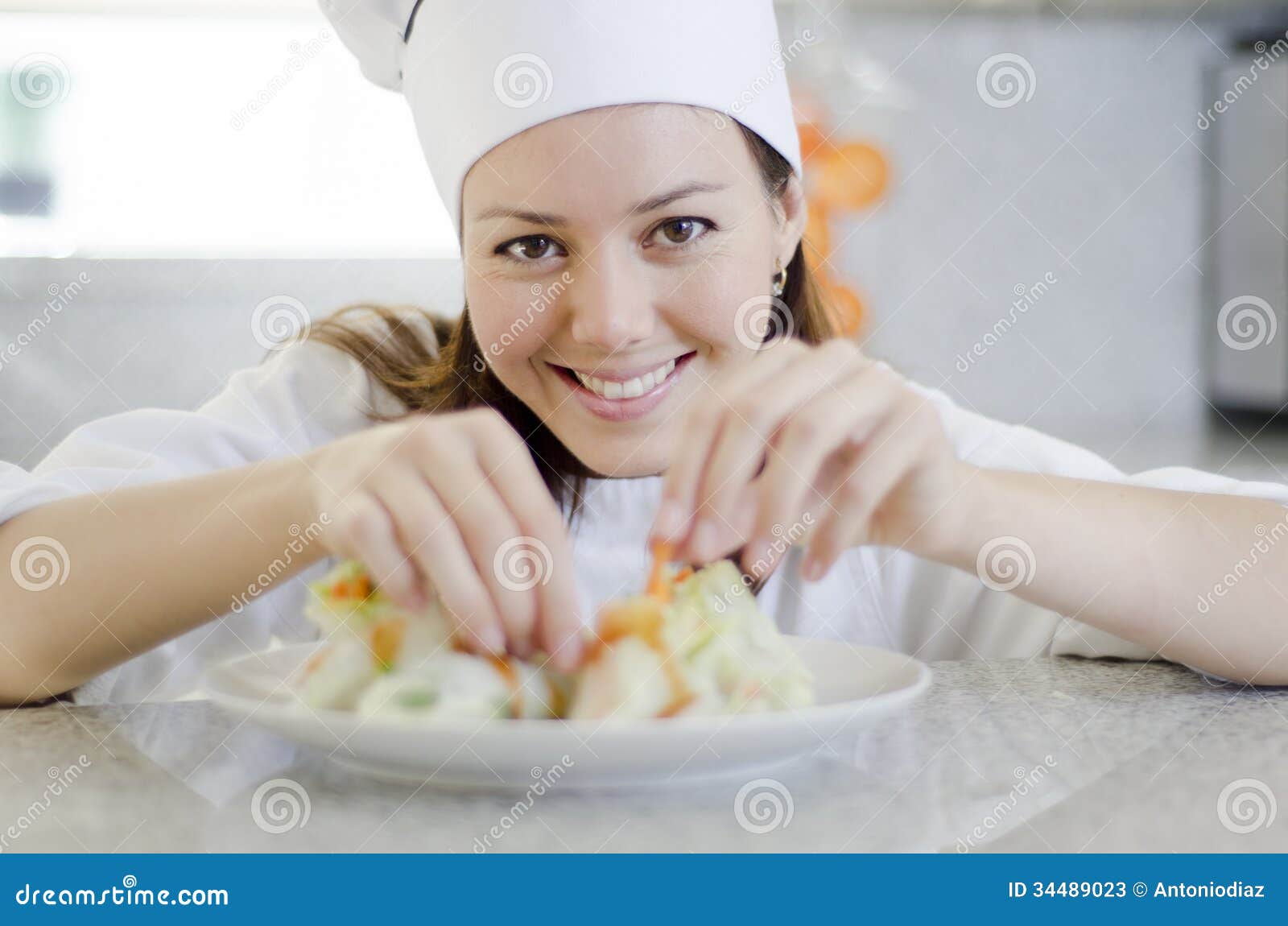 Pretty female chef at work stock image. Image of chef - 34489023