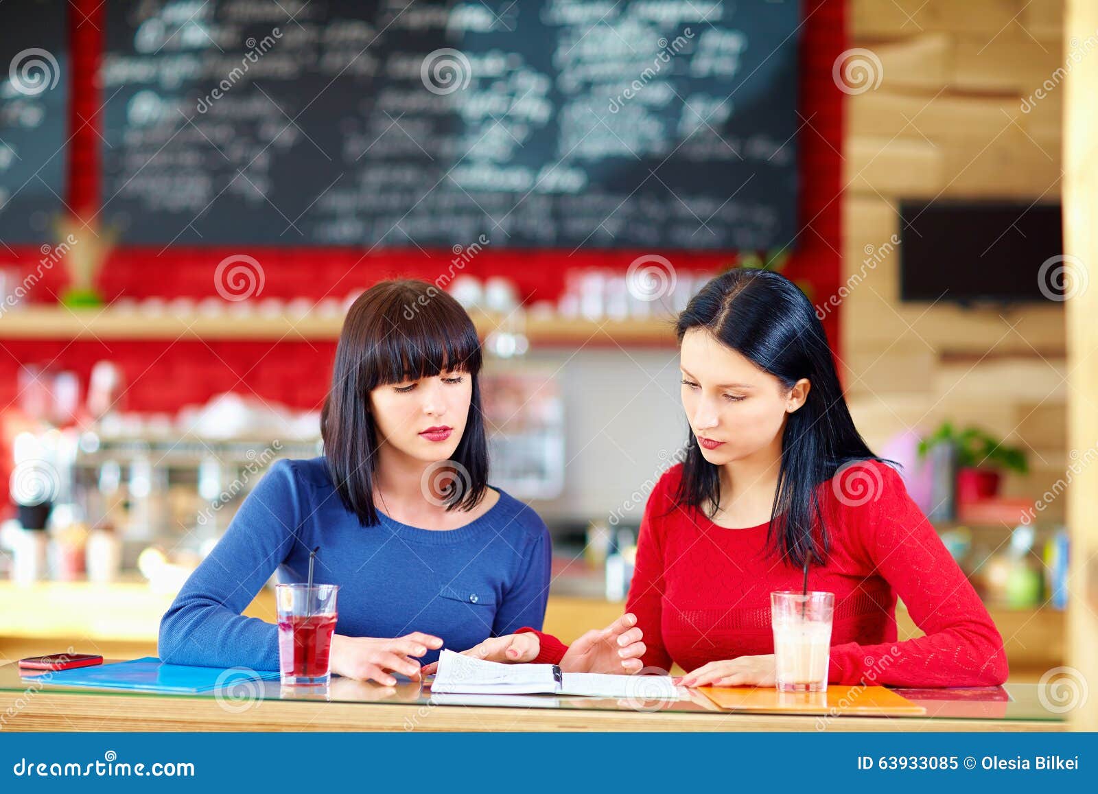 Pretty Female Friends Studying in Cafe Stock Image - Image of candid ...