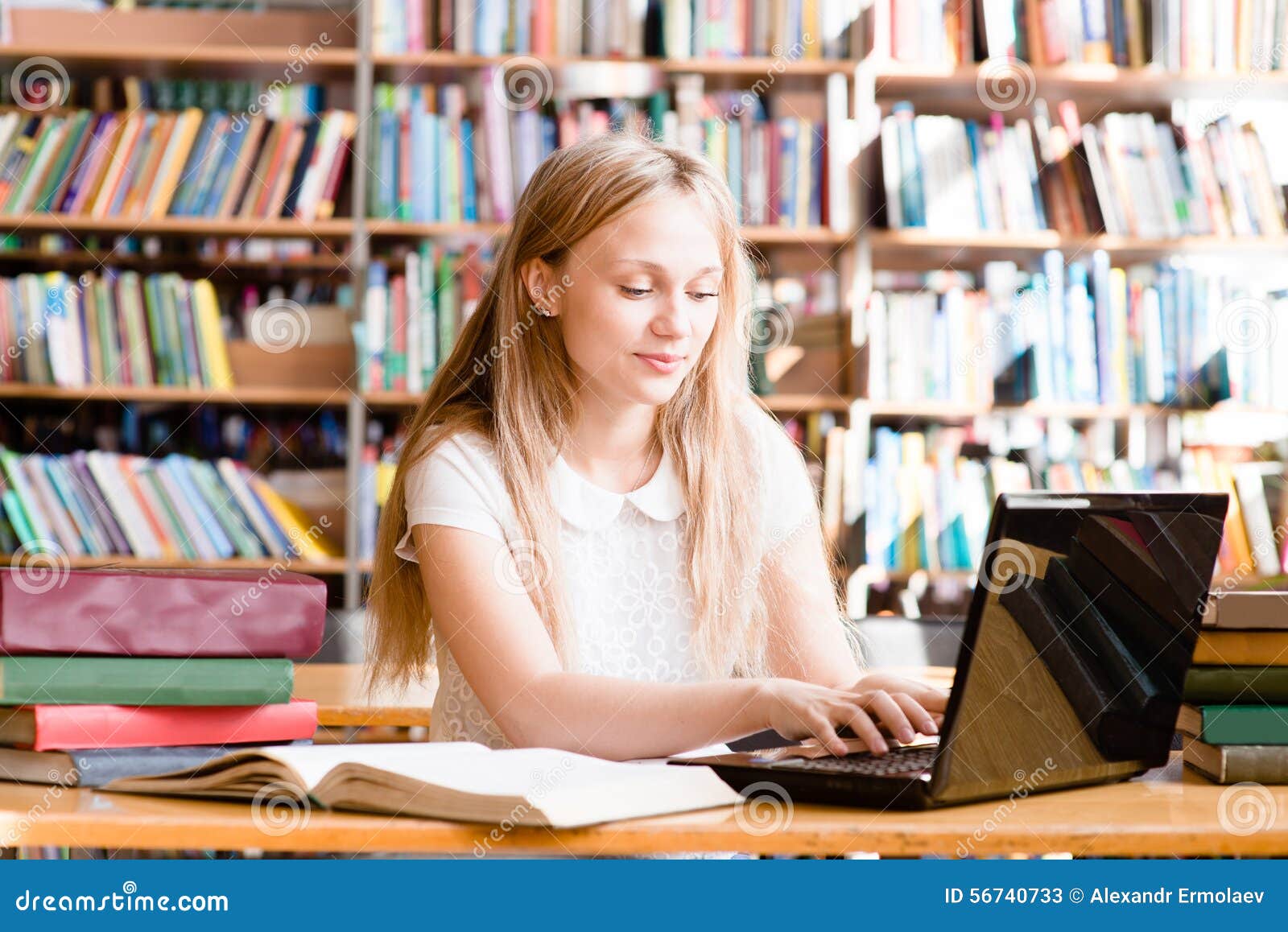 Pretty Female Student Typing on Notebook in Library Stock Image - Image ...