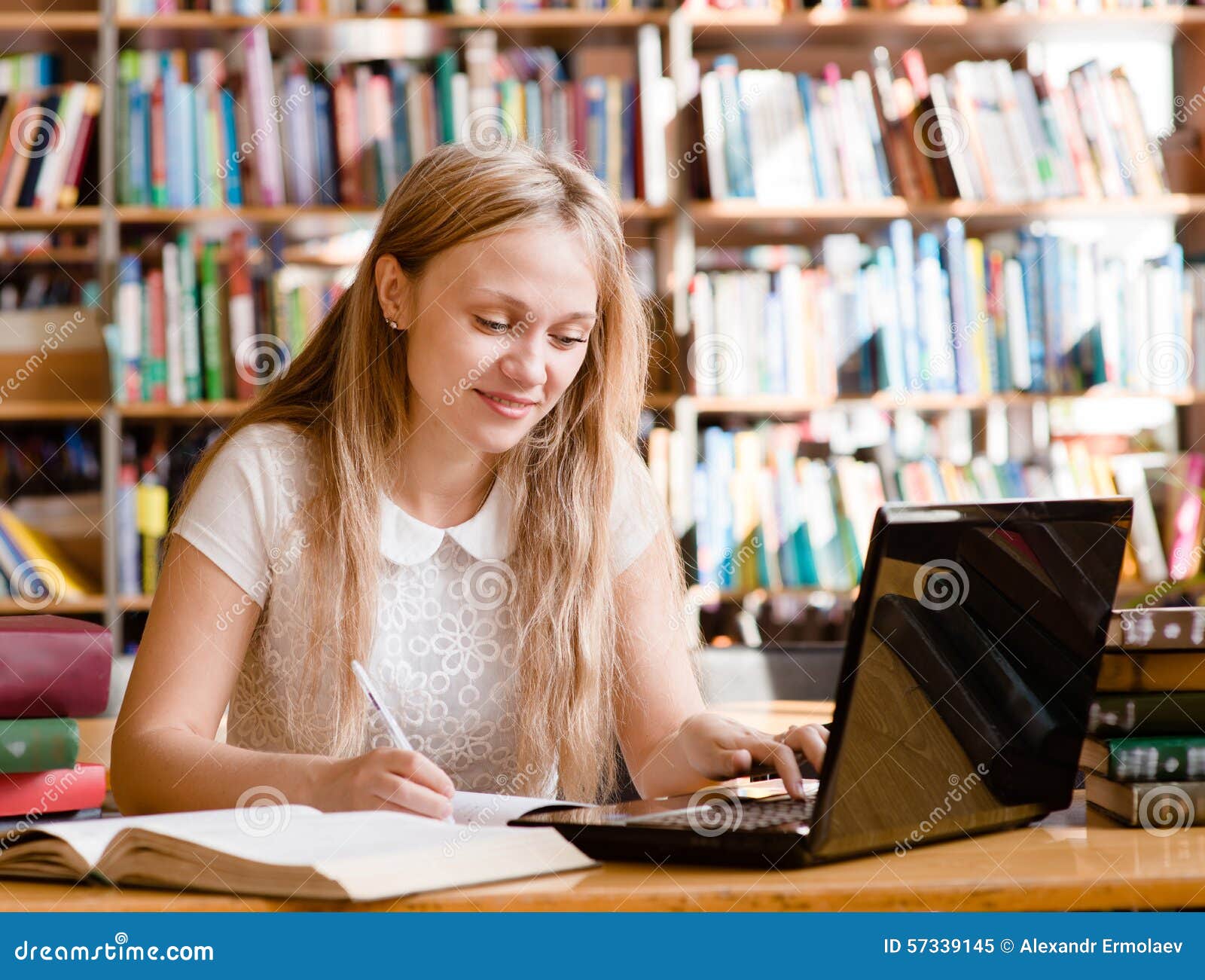 Pretty Female Student Typing on Notebook in Library Stock Image - Image ...