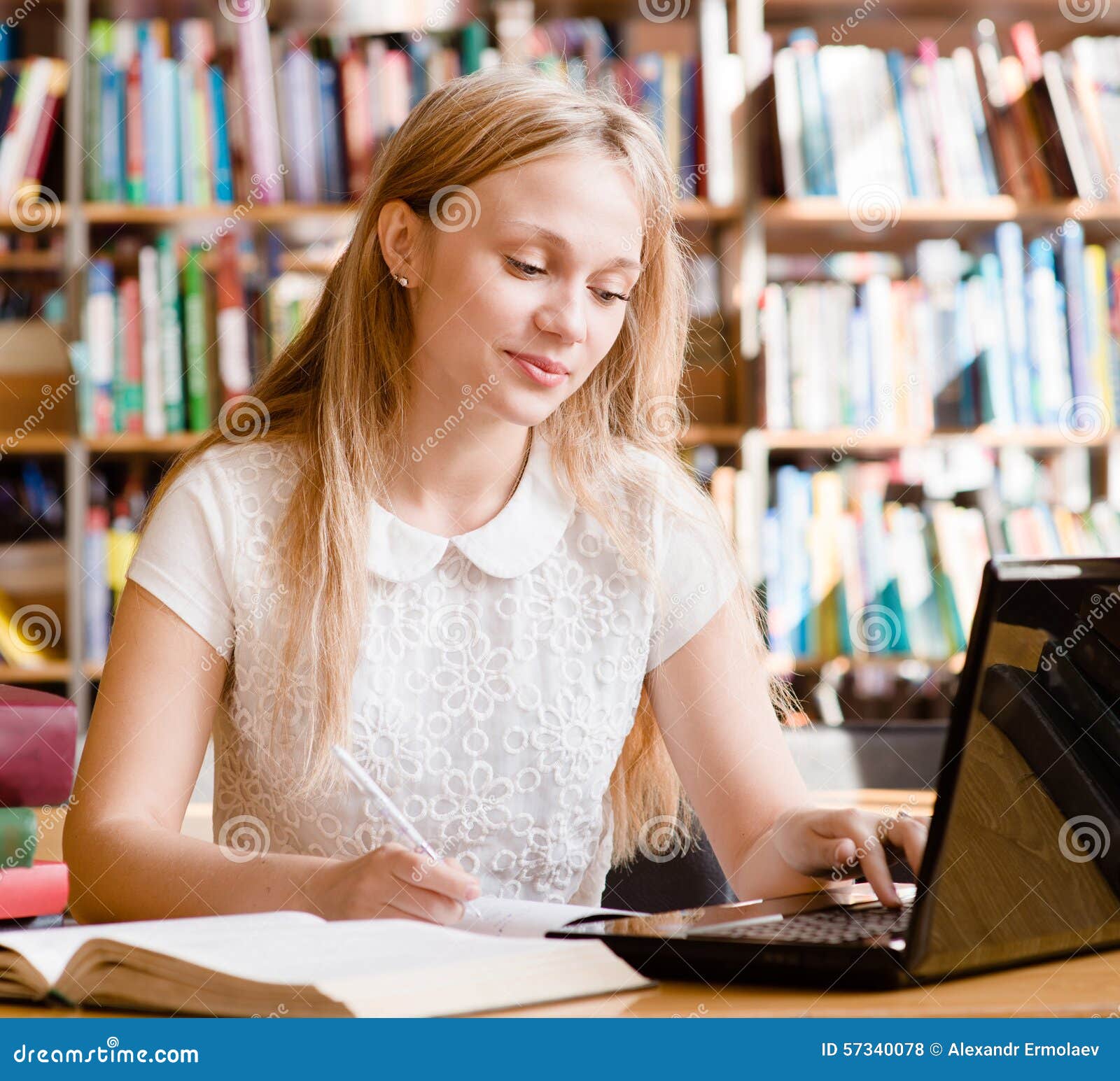 Pretty Female Student Typing on Notebook in Library Stock Photo - Image ...