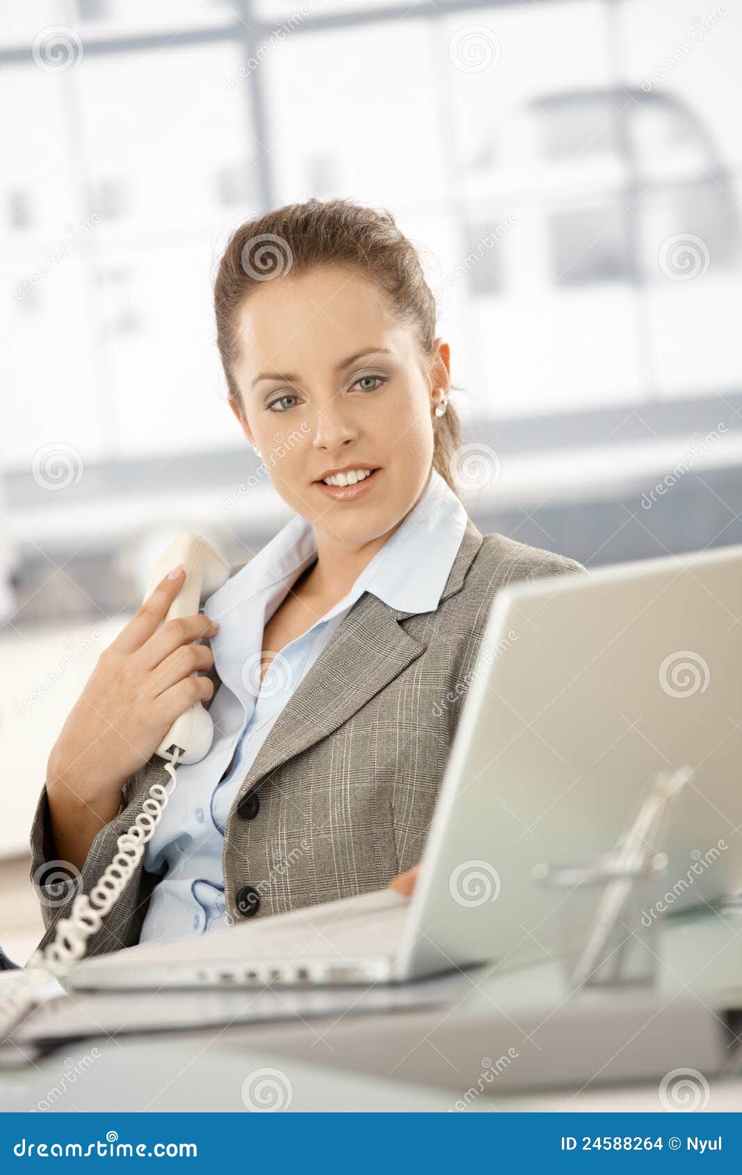 Pretty Female Using Phone and Laptop in Office Stock Photo - Image of ...