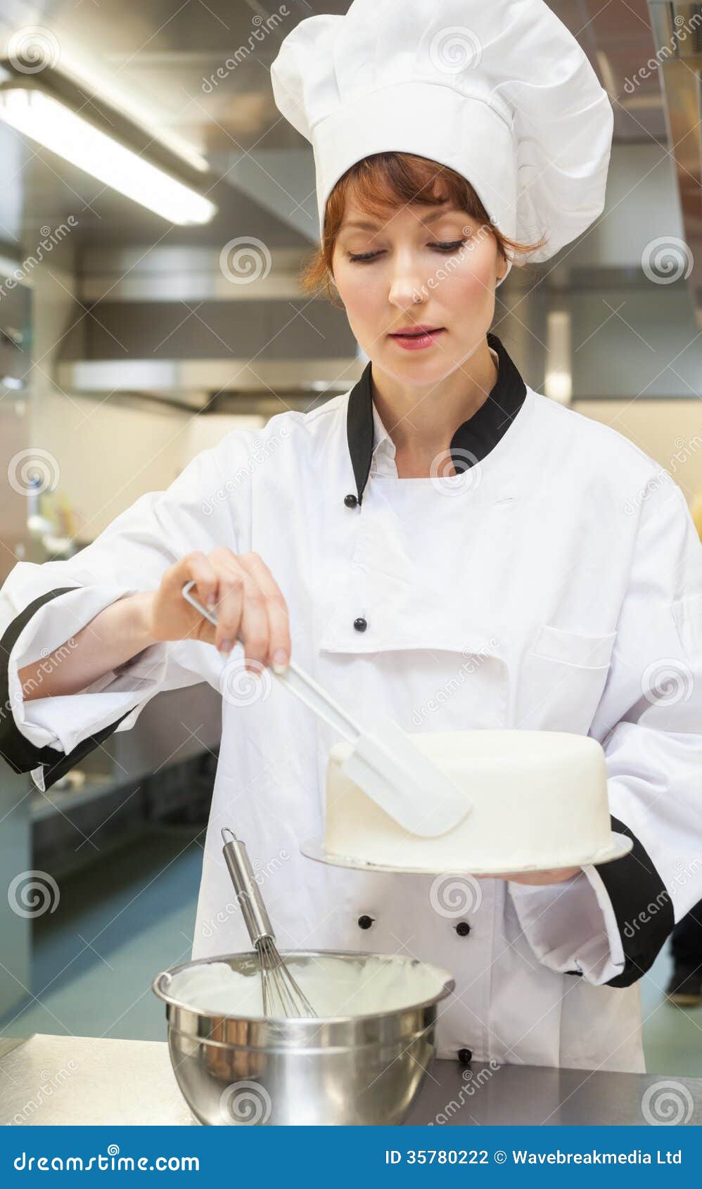 Pretty Focused Head Chef Finishing a Cake with Icing Stock Photo ...