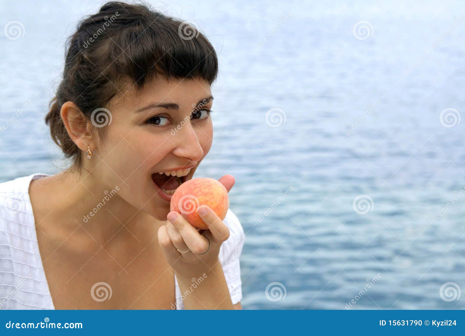 Pretty girl eating peach stock photo. Image of outdoor - 15631790