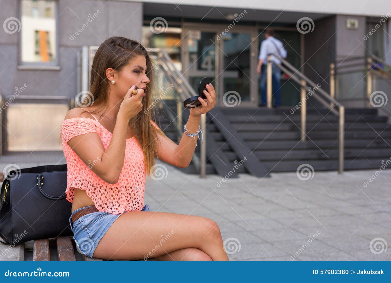 Pretty Girl Fixing Her Make-up while Waiting for Her Date. Stock Photo ...