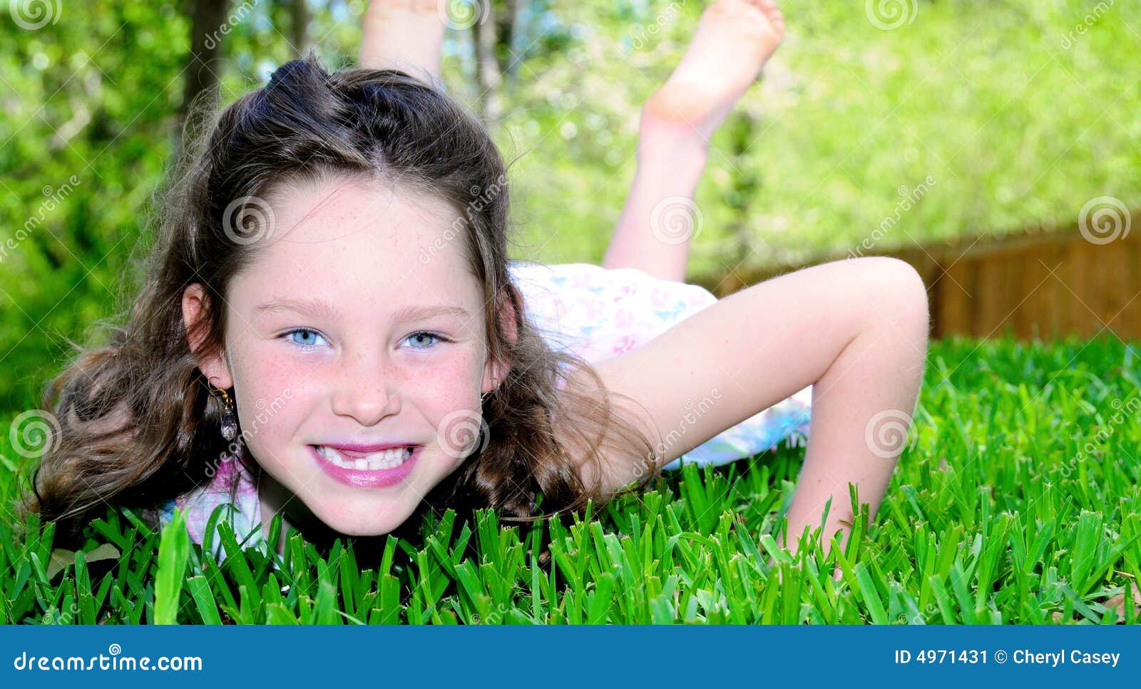Pretty girl in grass stock image. Image of girl, recess - 4971431