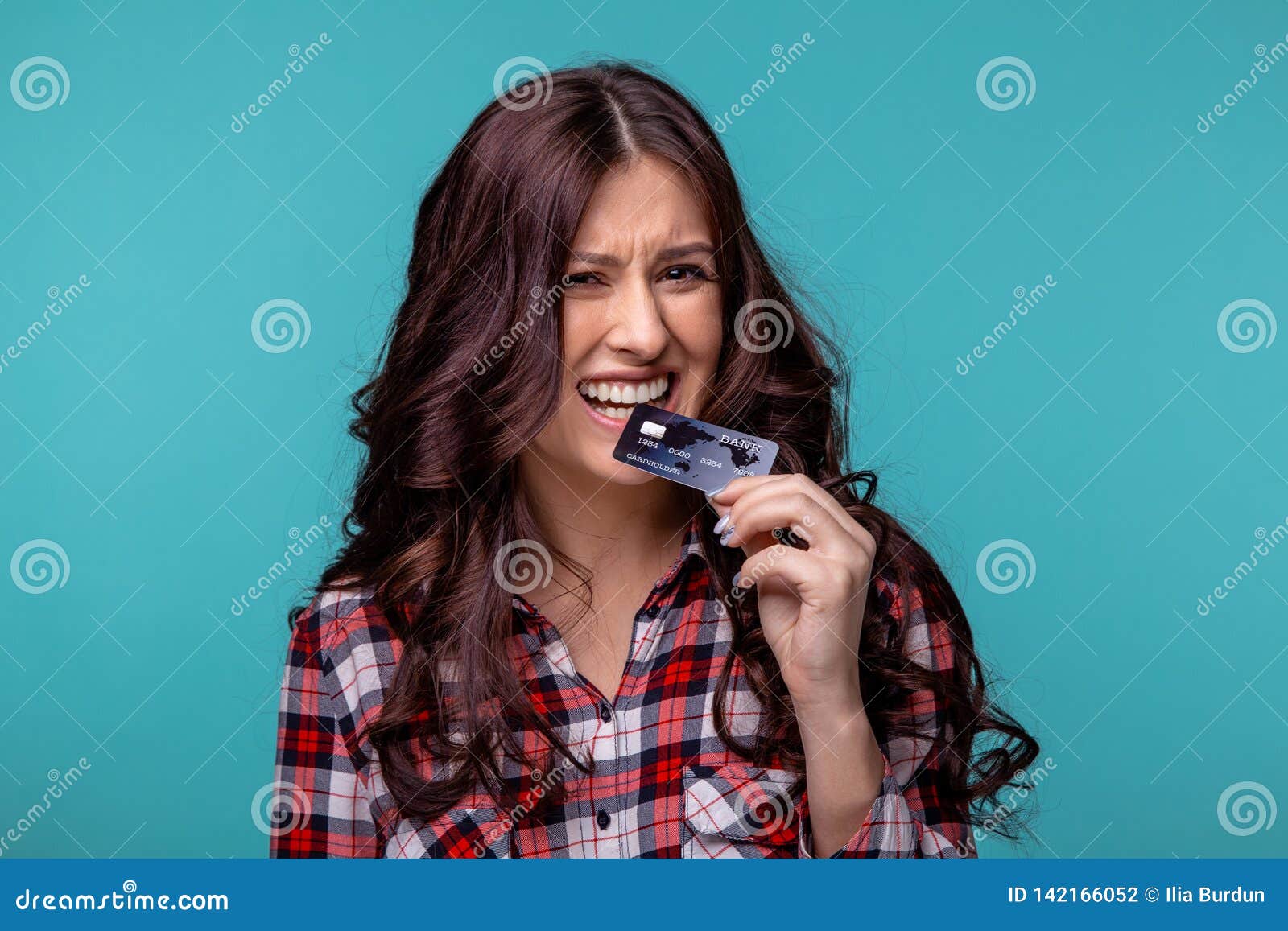 Pretty Girl Holding Credit Card Isolated Over the Blue Background ... Pretty Girl Holding Credit Card Isolated Over the Blue Background ...