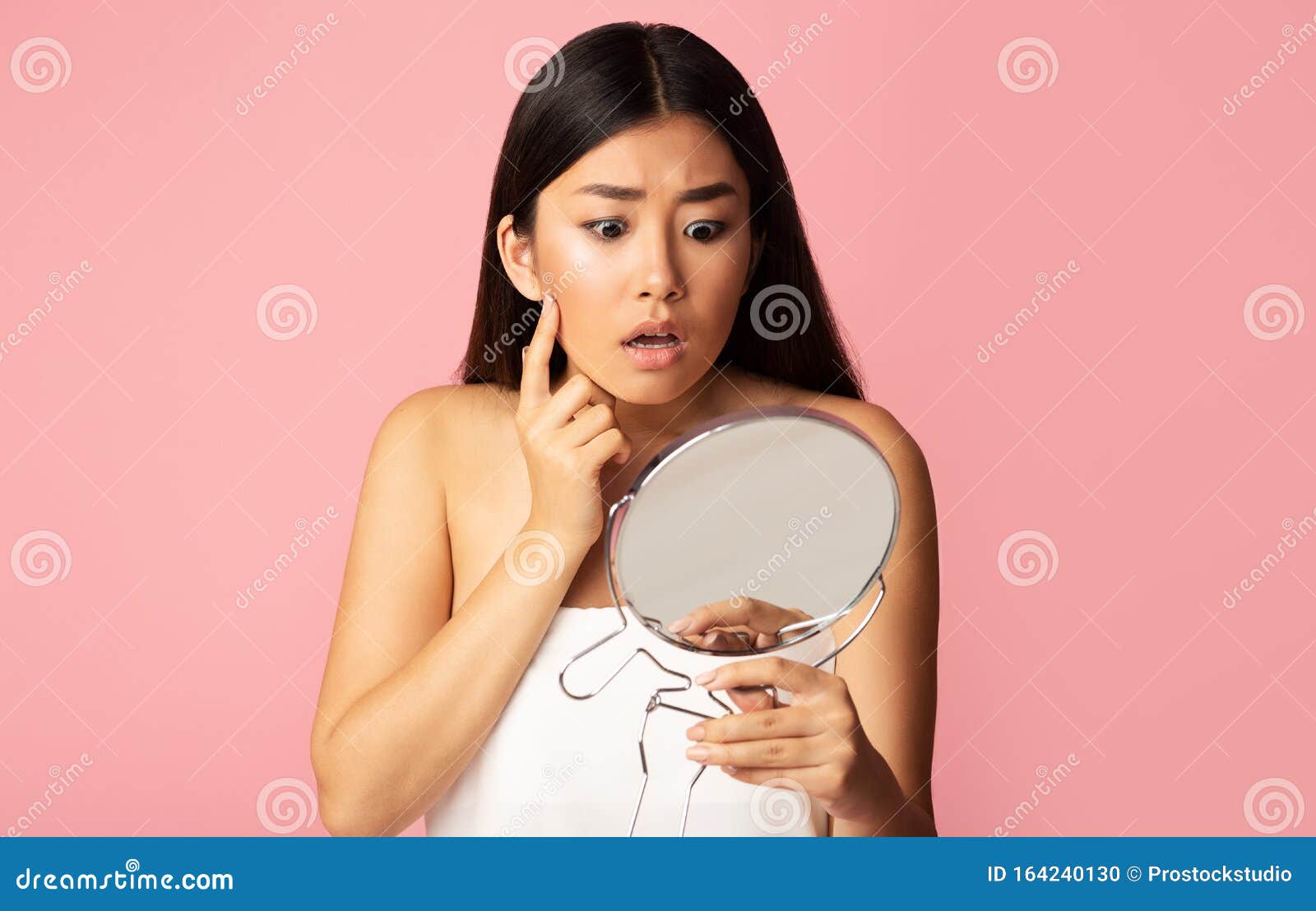 Pretty Girl Holding Mirror Touching And Worrying About Her Face Stock
