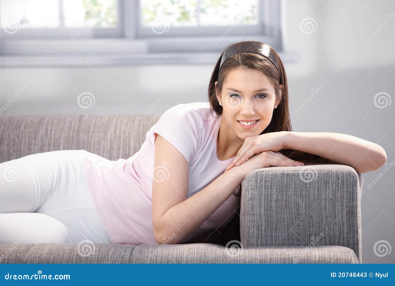 Pretty Girl Laying On Sofa Smiling Stock Photos - Image: 20748443