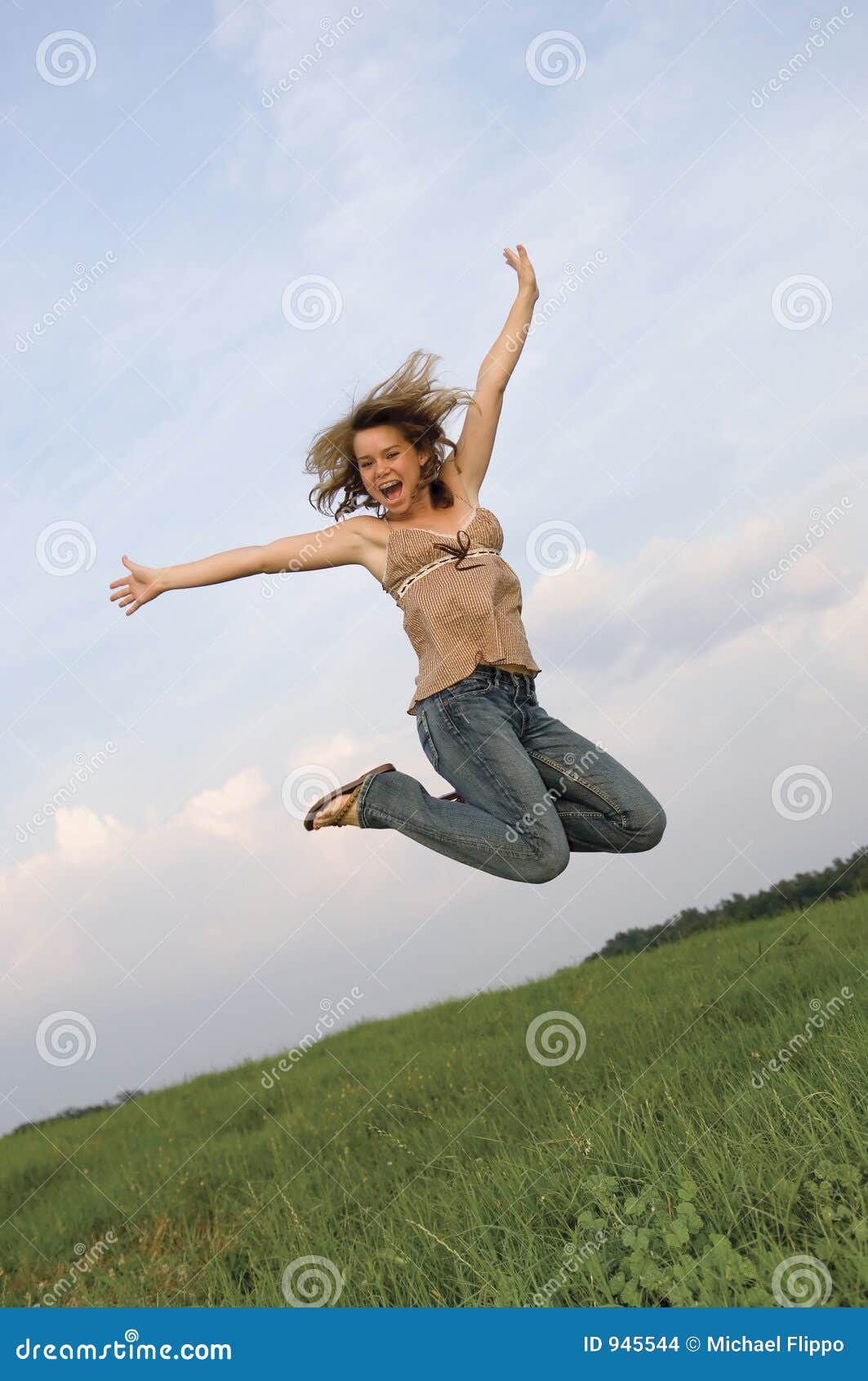 Pretty Girl Leaping in Field Stock Photo - Image of yelling, smiling ...