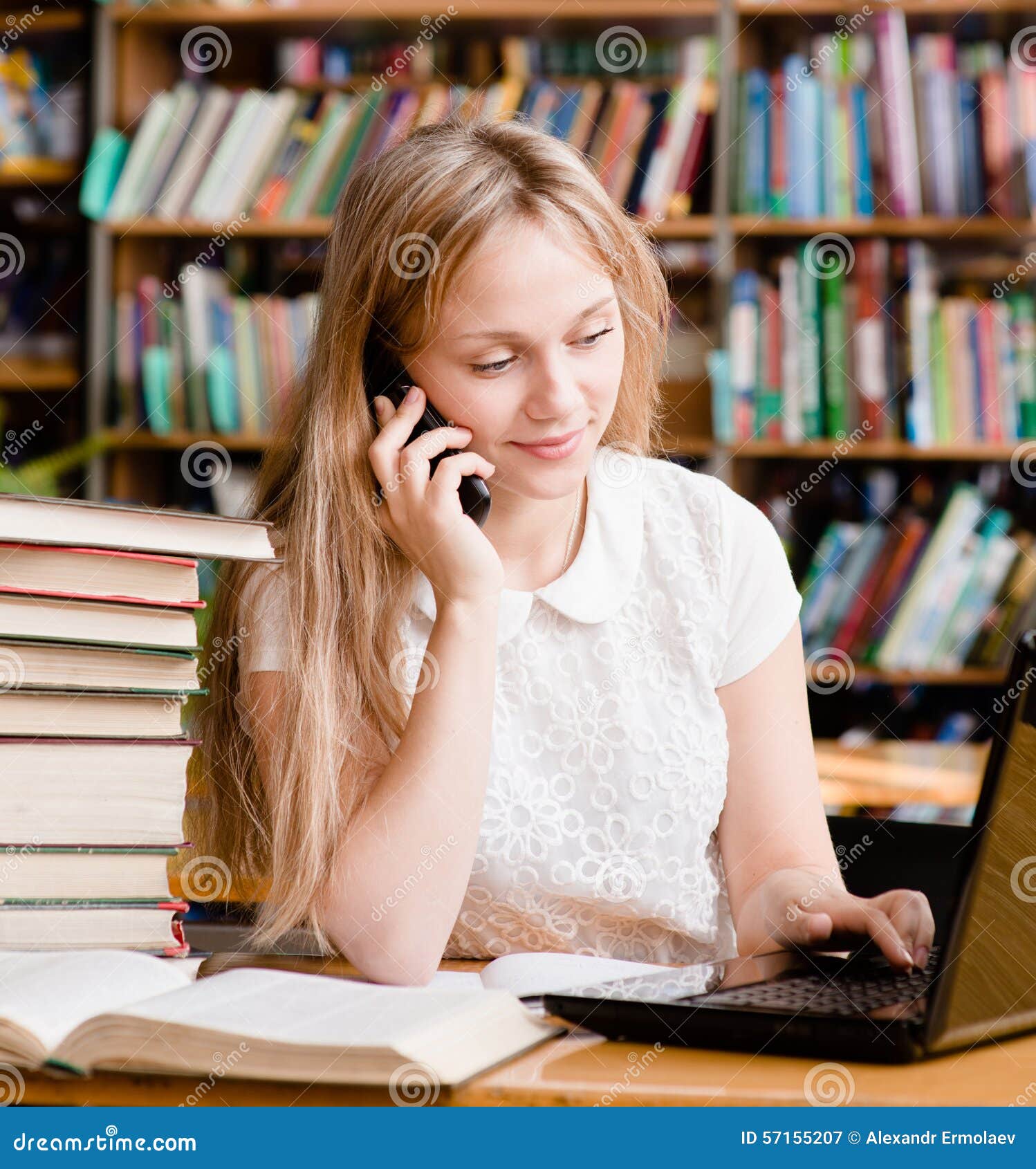 Pretty Girl in Library Typing on Laptop and Talking on the Phone Stock ...