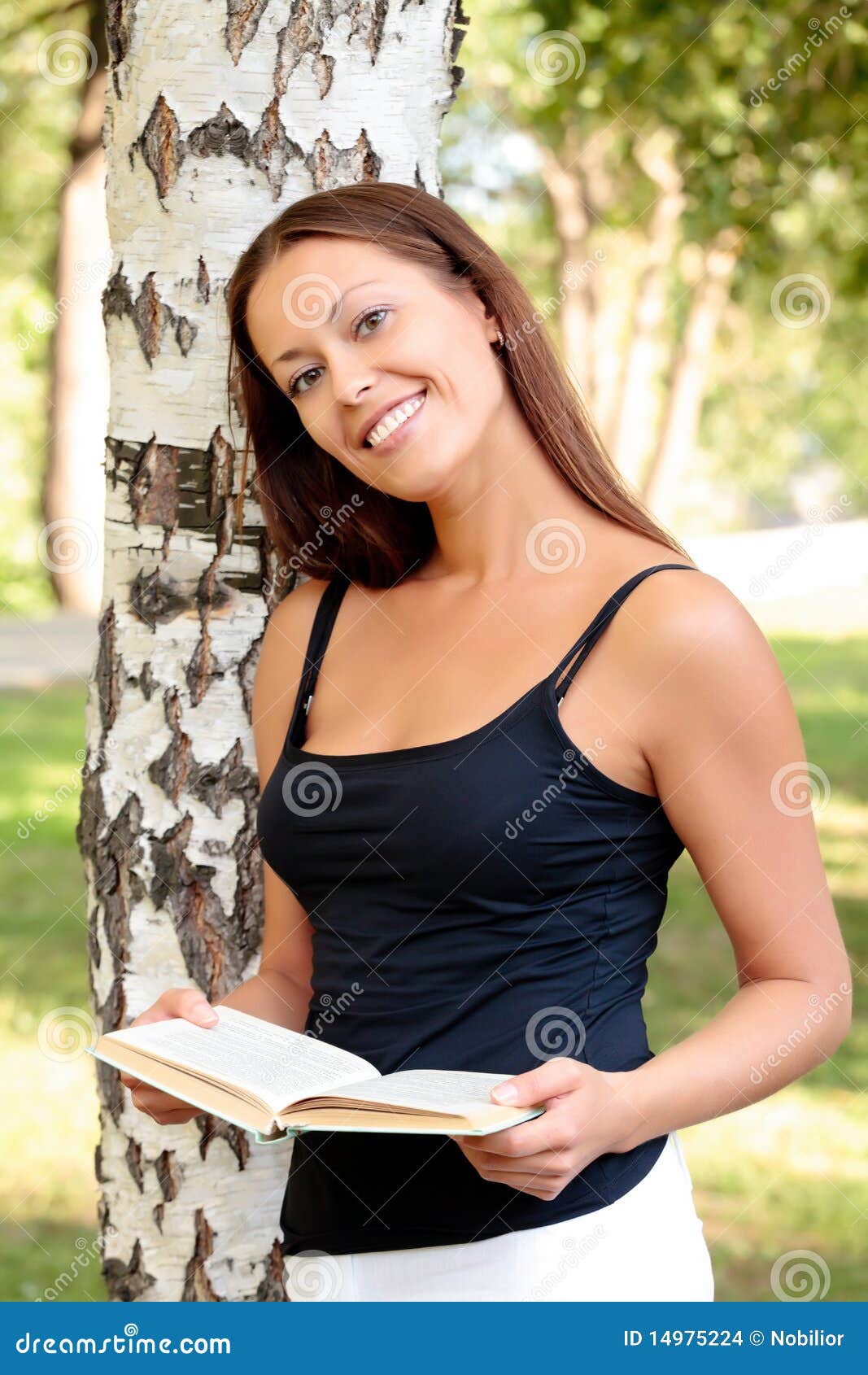 Pretty girl reading a book stock photo. Image of brunette - 14975224