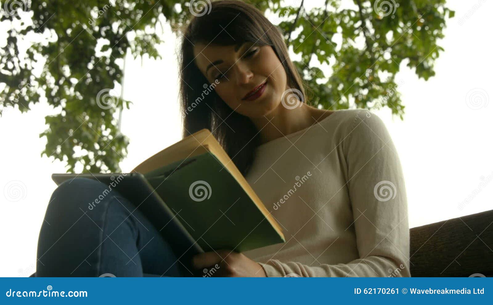 Pretty girl reading a book stock video. Video of female - 62170261