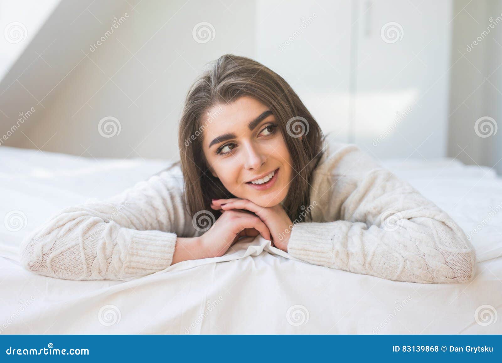 Pretty girl smiling in bed stock photo. Image of light - 83139868