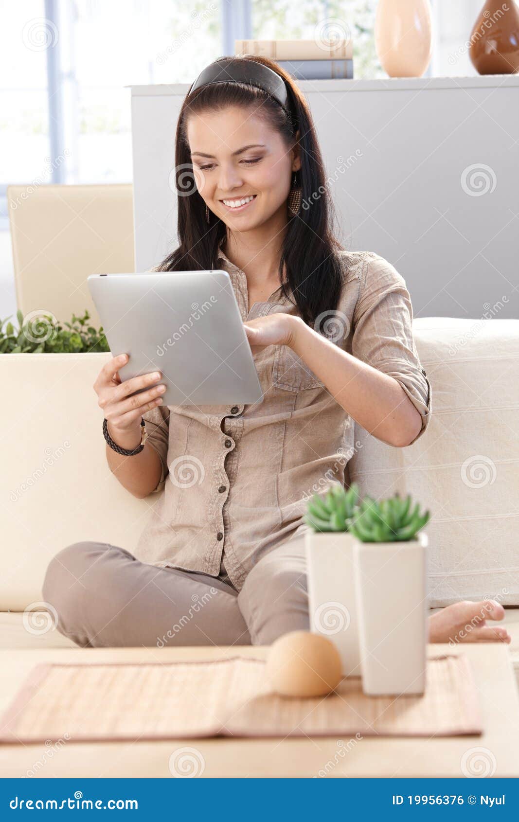 Pretty Girl Using Tablet at Home Smiling Stock Photo - Image of ...