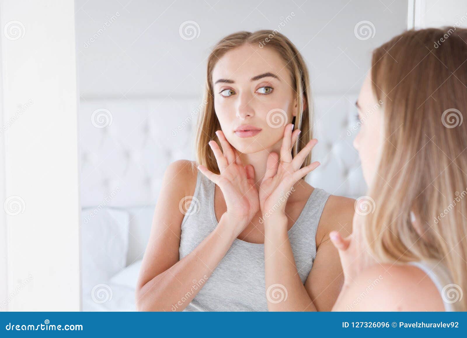 Pretty Girl Woman Touching Her Neck While Looking In The Mirror