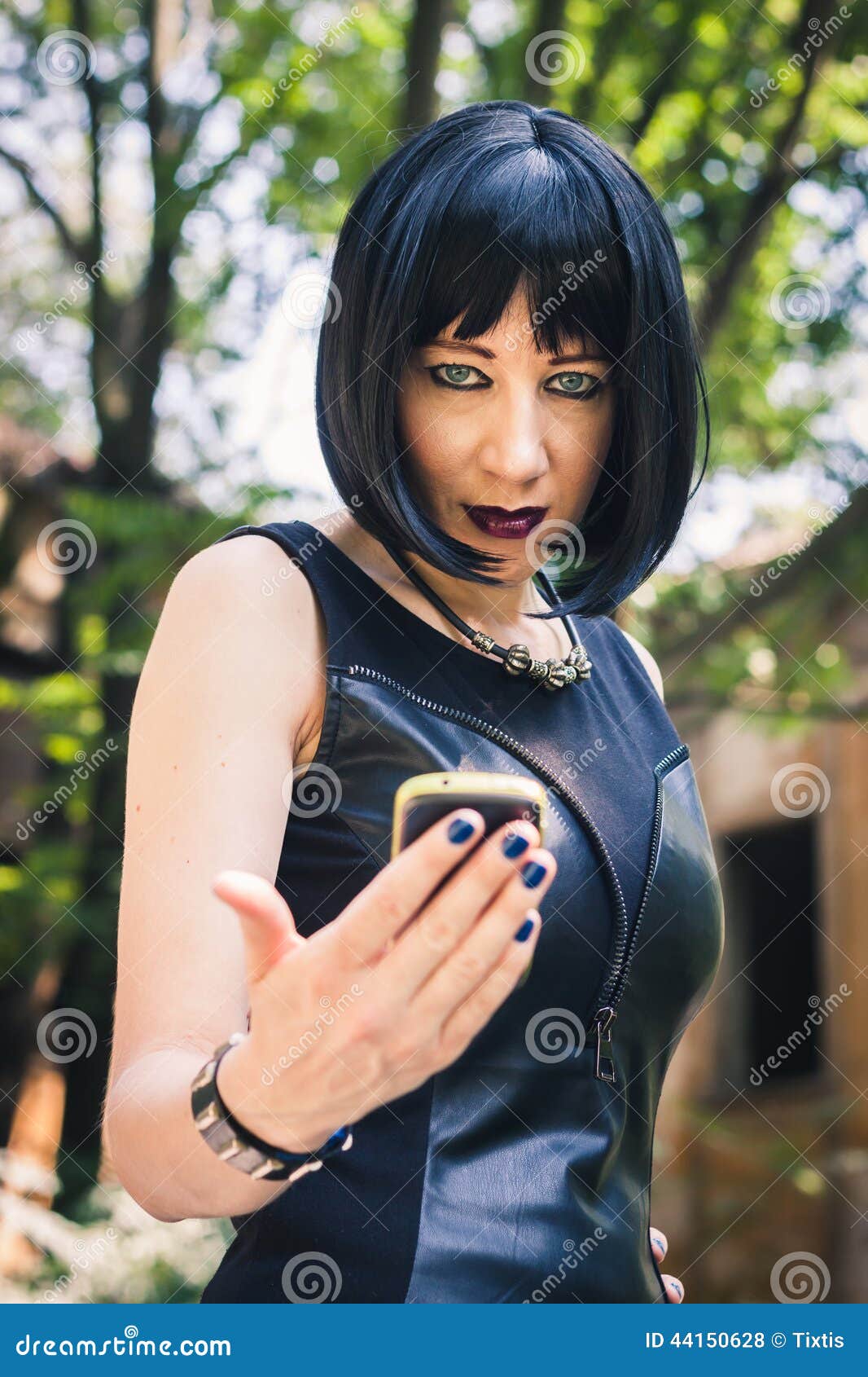 Pretty Goth Girl Using Phone in a City Park Stock Photo - Image of ...