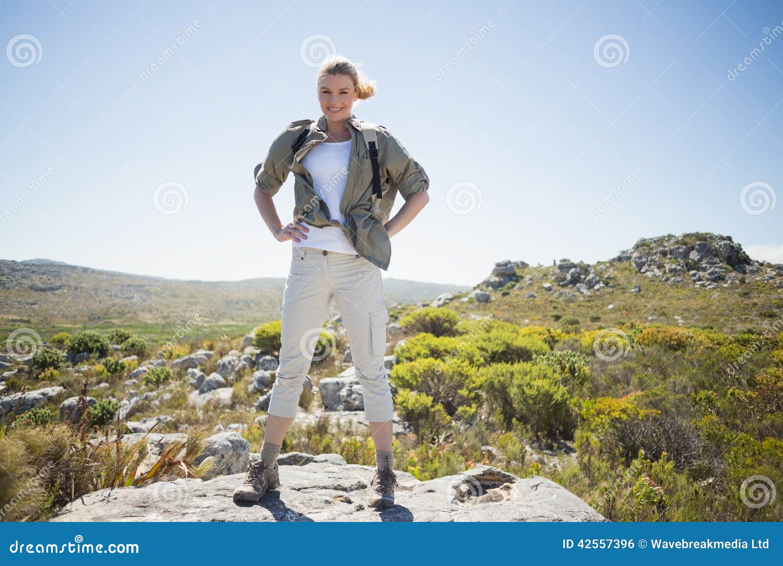 Pretty Hiker Standing at the Summit Smiling at Camera Stock Photo ...