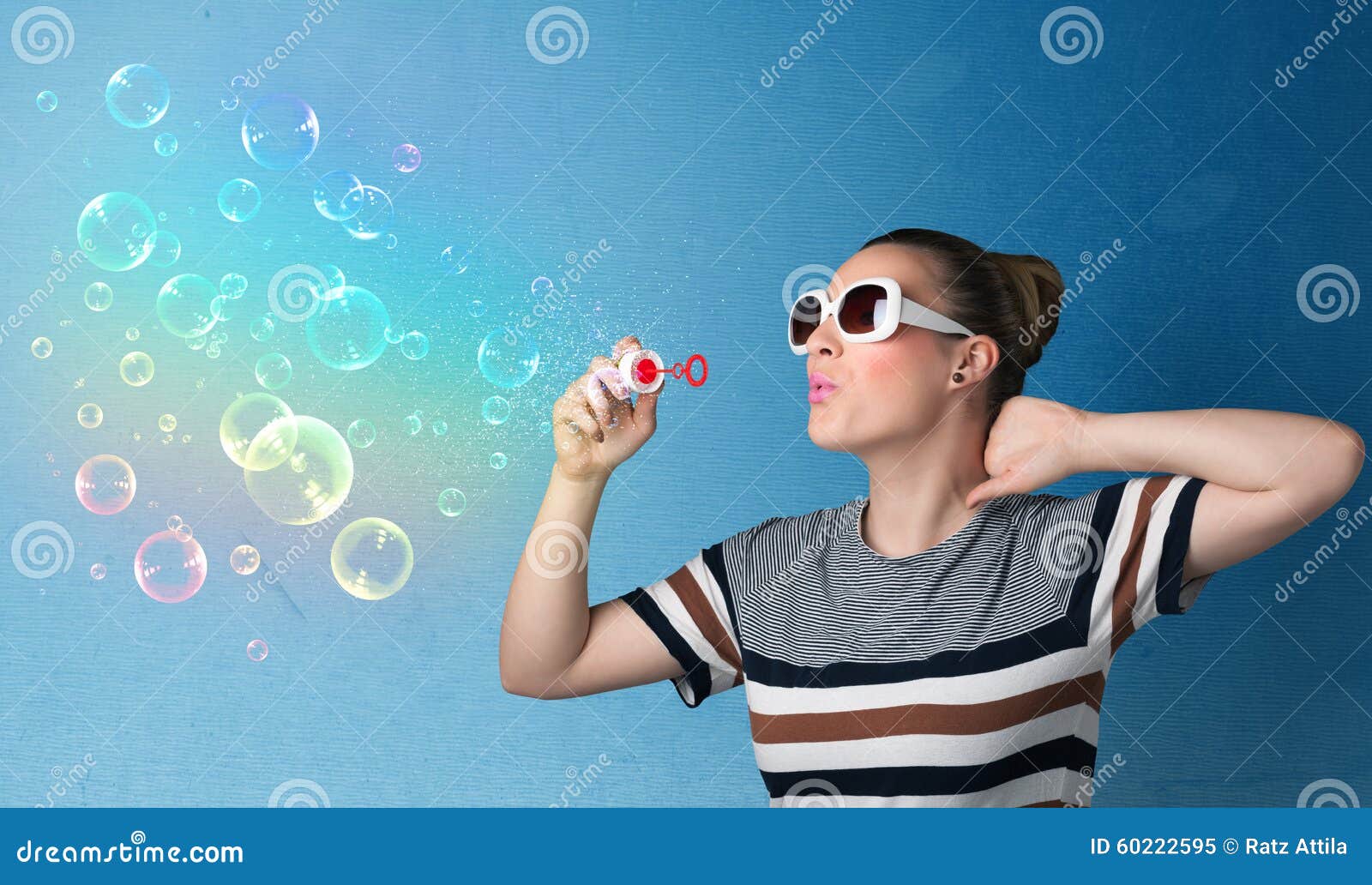 Pretty Lady Blowing Colorful Bubbles on Blue Background Stock Image ...